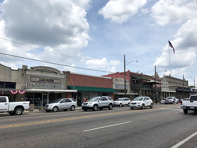 Pine Street showcases Ponchatoula's perfectly preserved commercial architecture, where modern cars park alongside buildings that have witnessed a century of change.