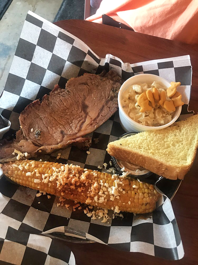 The dining area's corrugated metal walls and string lights create the perfect backdrop for the serious business of BBQ appreciation. No pretension, just passion.