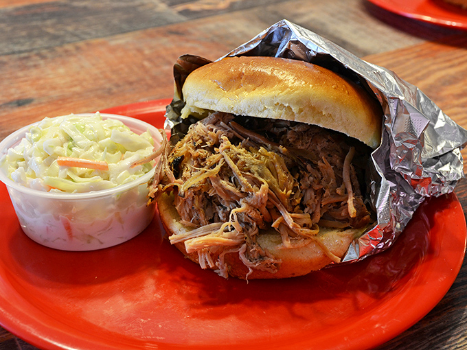 A pulled pork sandwich that requires both hands and several napkins. That coleslaw isn't just a side&mdash;it's an essential textural counterpoint to the tender meat.