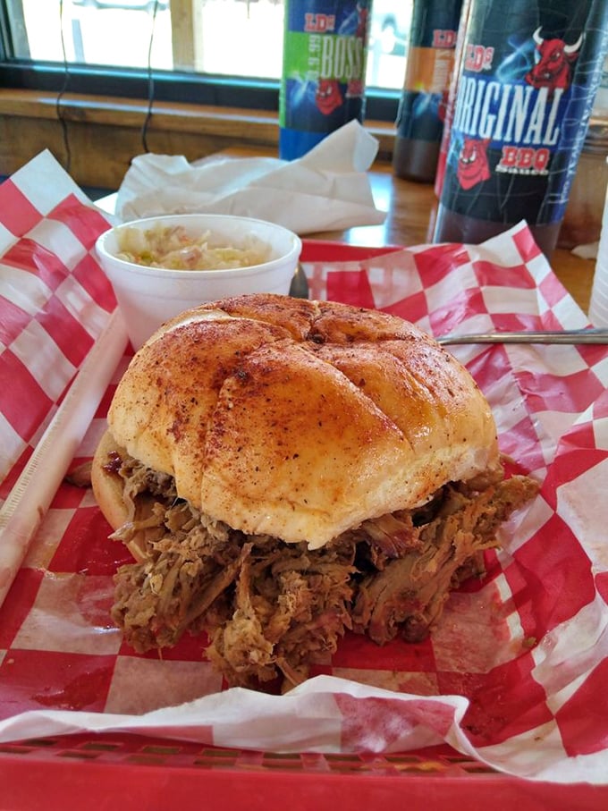 This pulled pork sandwich isn't just lunch—it's what happiness would look like if it took physical form and sat on a red checkered paper.