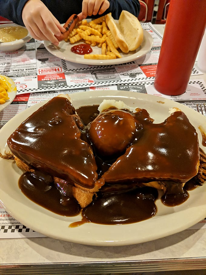 Not just a hot beef sandwich but a brown gravy waterfall cascading over tender meat islands&mdash;comfort food geography at its finest.