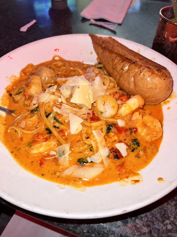 Pasta swimming in a sunset-colored sauce with shrimp playing the starring role—the baked potato on the side watching like a carb-loaded spectator.