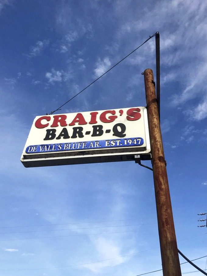 That sign against the Arkansas sky has guided hungry travelers for generations. Like a barbecue lighthouse in a sea of chain restaurants.
