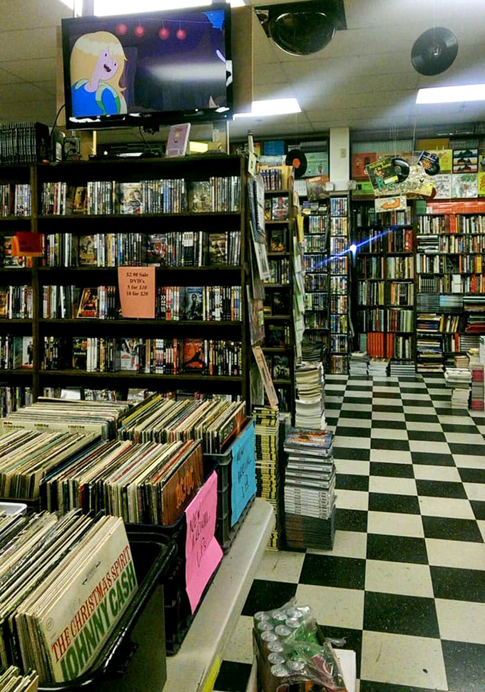 Adventure awaits at the end of every aisle, with DVDs and vinyl adding to the media mix. That checkered floor has seen countless literary pilgrimages.