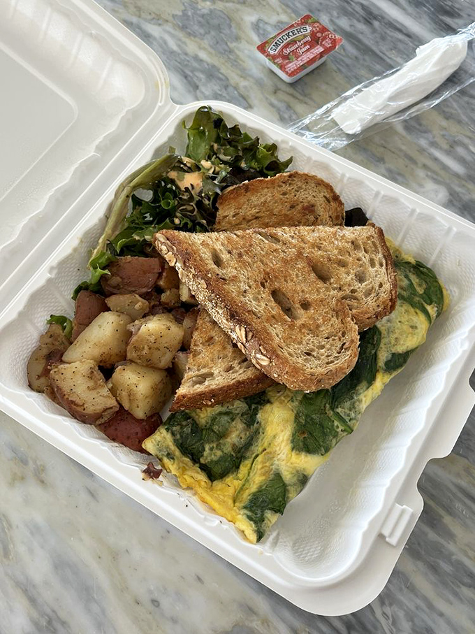 An omelet that actually respects its vegetables, letting spinach and feta shine instead of drowning them in a sea of overcooked eggs.