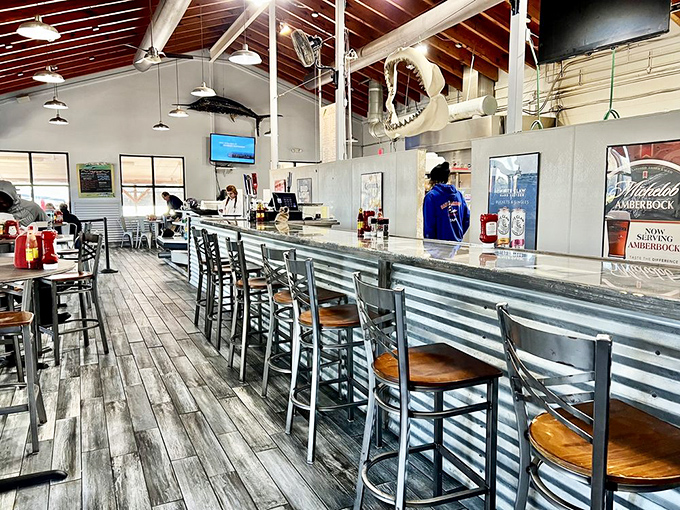 Where nautical meets practical: corrugated metal meets wooden stools. The kind of bar where fish stories get better with each local beer.