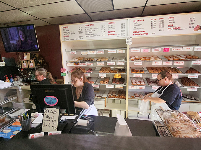 The wizards behind the counter, crafting donut magic with the calm efficiency that comes from thousands of mornings doing what they love.