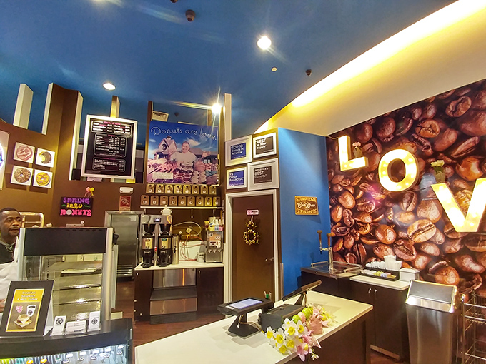 The blue ceiling and warm wood tones create the perfect backdrop for showcasing what matters most &ndash; handcrafted donut perfection.