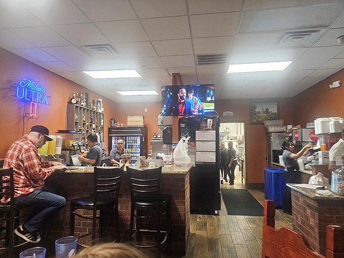The bar area—where sports on TV and tequila on shelves create that perfect "I could stay here all afternoon" atmosphere.