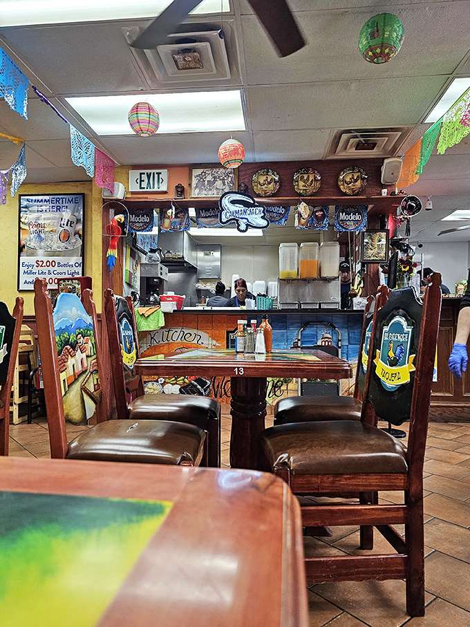 Colorful papel picado and beer signs create that perfect "you're about to eat something amazing" atmosphere. The kitchen beckons with promises.