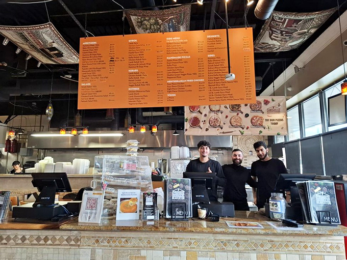 The culinary wizards behind the Mediterranean magic. Their smiles suggest they know exactly how good their food is.