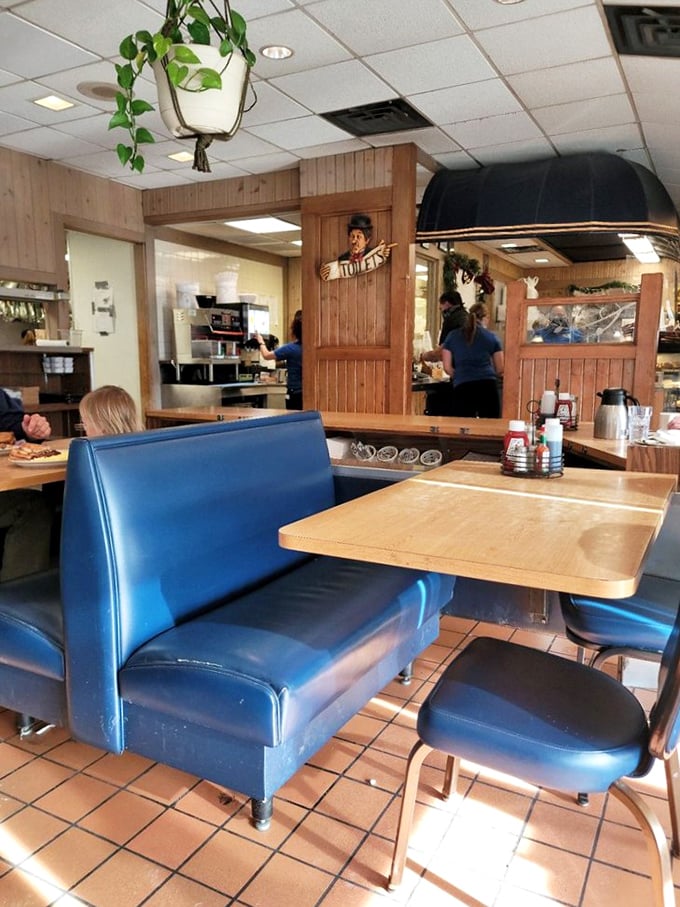 Classic diner seating that invites you to settle in and stay awhile. The hanging plants add a touch of homey charm.
