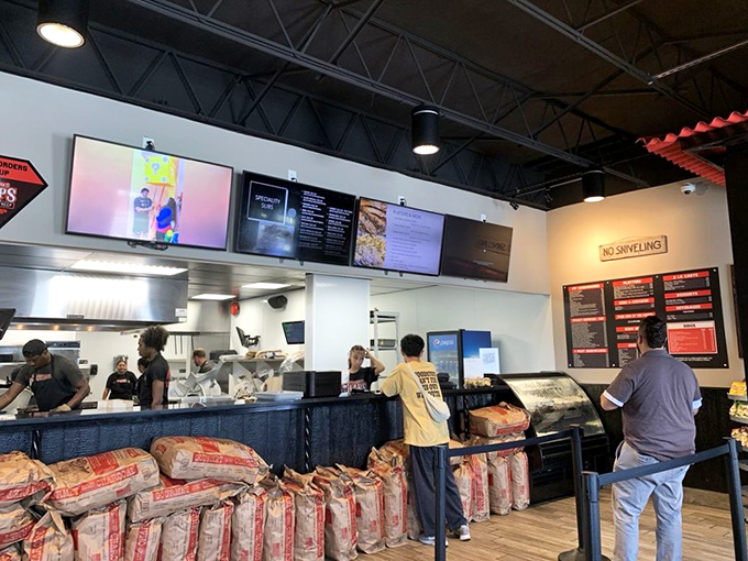 The front lines of flavor. These folks aren't just staff—they're gatekeepers to a smoky paradise of pit-cooked perfection.