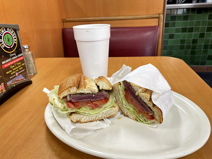 A sandwich cut in half not because it needed to be, but so you could appreciate the architectural marvel of its perfectly layered contents.