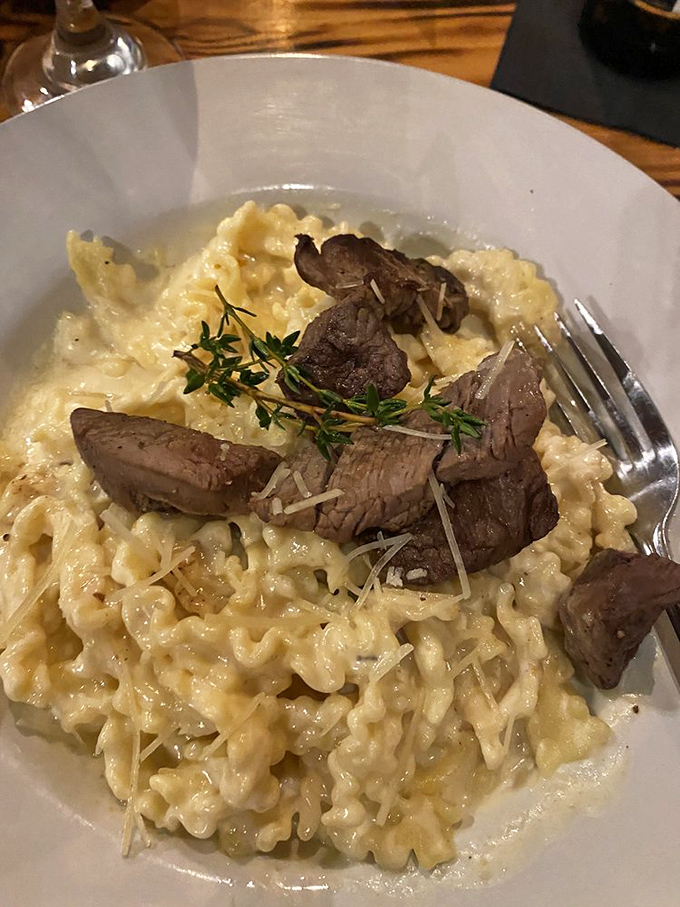 Creamy risotto cradles tender steak bites like a parent holding a newborn. That thyme sprig isn't garnish&mdash;it's the conductor of this flavor orchestra.