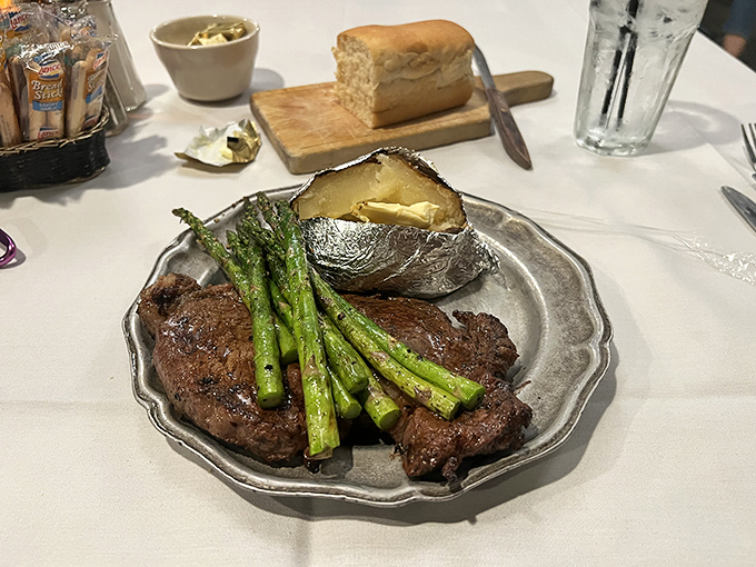 A plate that speaks volumes. The perfectly seared steak with vibrant asparagus and loaded potato creates the holy trinity of steakhouse perfection.