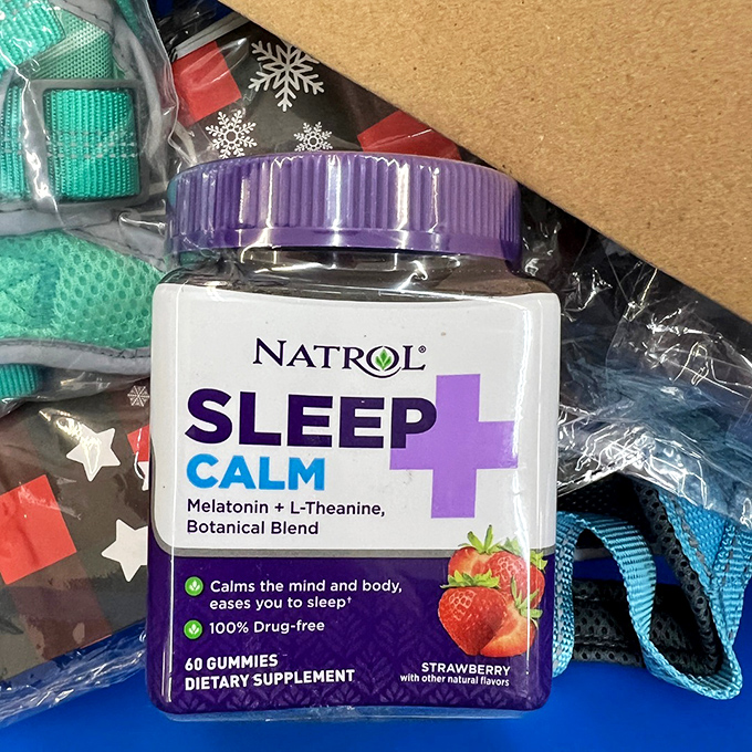 Sleep supplements nestled among holiday wrapping—the perfect metaphor for surviving family gatherings with your sanity intact.