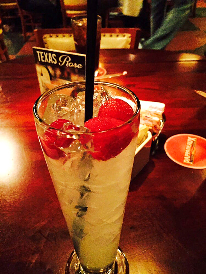 The Texas Rose cocktail&mdash;a refreshing blend that tastes like summer in a glass. Those berries aren't just garnish; they're little flavor bombs.