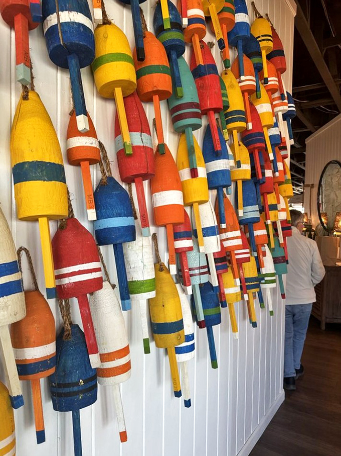 This wall of buoys isn't just décor—it's a technicolor timeline of Eastern Shore maritime history that makes waiting for your table an unexpected pleasure.