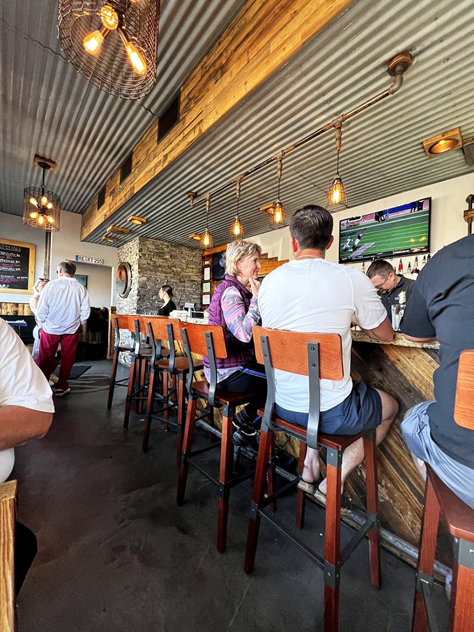 The bar area where strangers become friends over shared plates and the universal language of "wow, you have to try this."