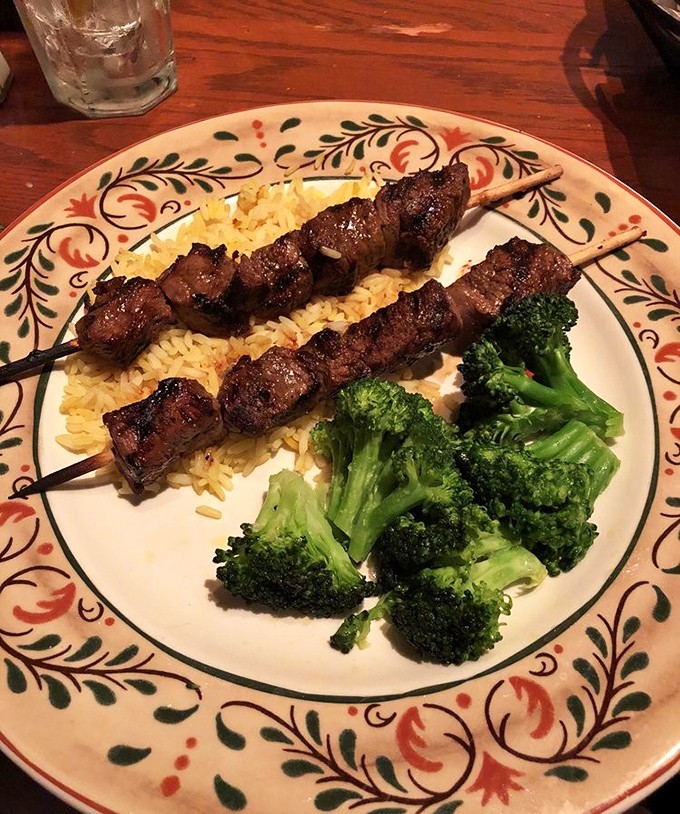 Beef skewers that make you realize why humans invented fire in the first place. That rice isn't just a side&mdash;it's catching flavor drips like a culinary safety net.