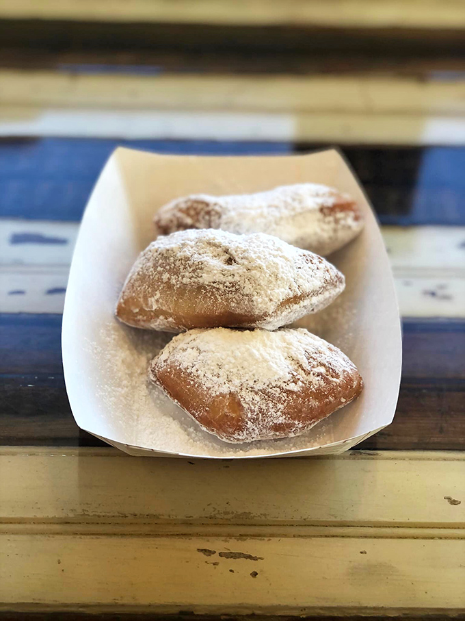 These aren't just beignets; they're pillowy clouds of fried dough dusted with powdered sugar that transport you straight to dessert heaven.