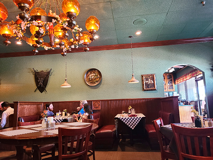 The dining room's rich wood booths and classic chandeliers create pockets of intimacy perfect for both first dates and fiftieth anniversaries.