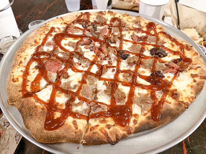 BBQ pizza that makes traditionalists question everything they thought they knew about proper pizza toppings. That drizzle of sauce is pure genius. 