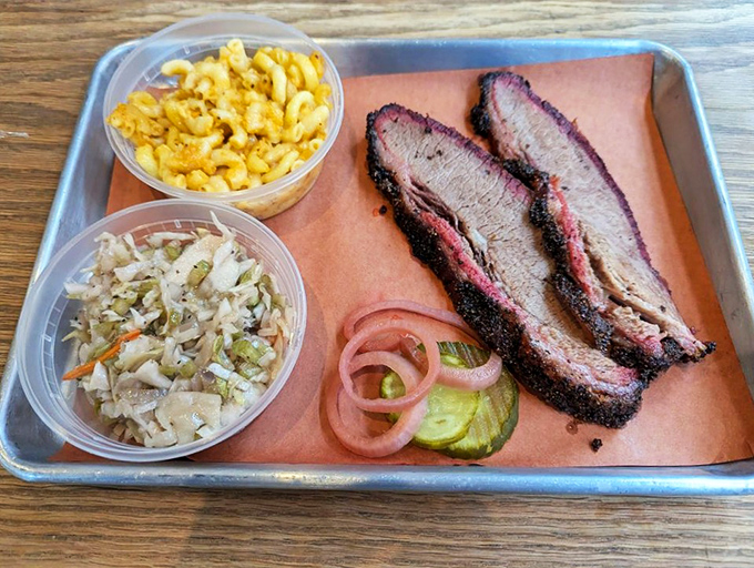 A barbecue still life: tender brisket with that telltale smoke ring, creamy mac and cheese, and slaw that cuts through the richness perfectly.