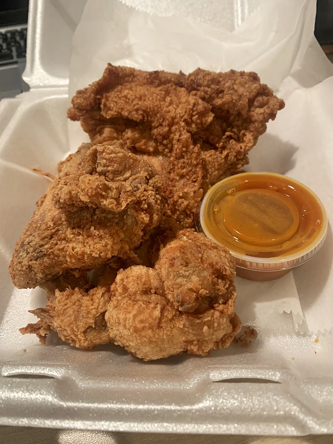Perfectly fried chicken pieces with that signature golden crust. The sauce cup isn't necessary, but it's there if you want to gild the lily.
