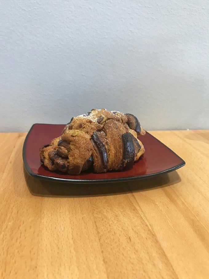 Not all heroes wear capes—some wear chocolate and pistachios. This croissant has dressed for the occasion of changing your life.