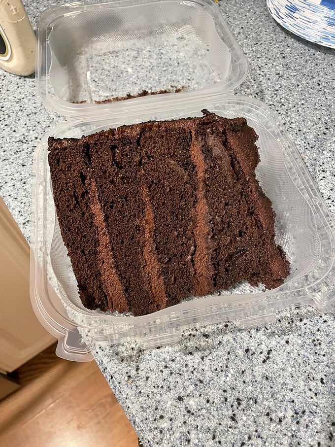 Chocolate cake to-go because sometimes the best part of dining out is having leftovers that make tomorrow's breakfast questionable but delightful.