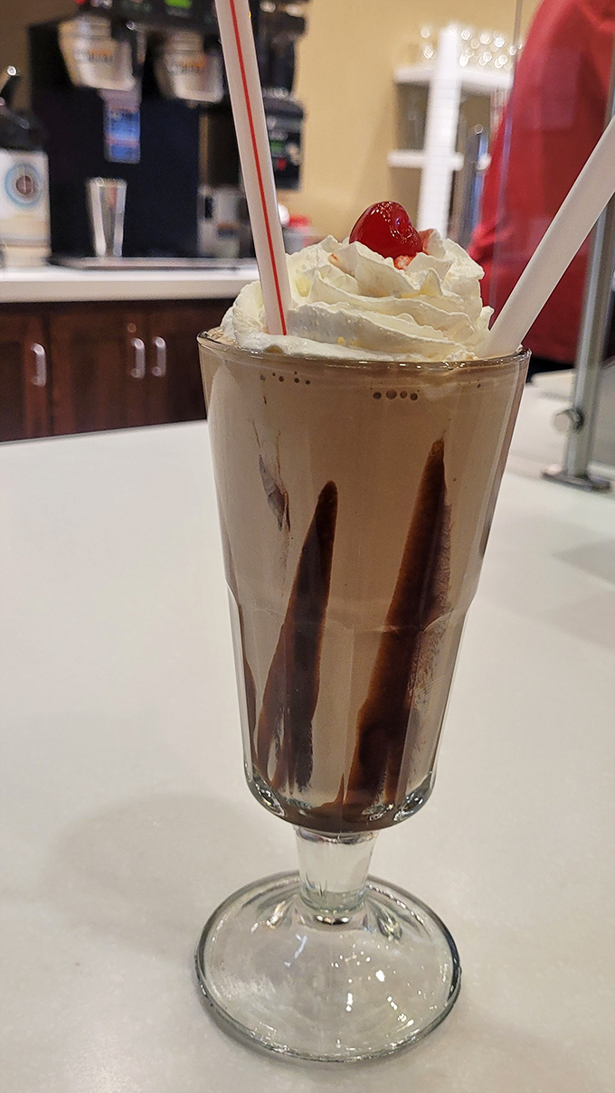 This chocolate milkshake isn't just thick—it's plotting to stage a rebellion against your straw while tempting you with those perfect fudge stripes down the glass.