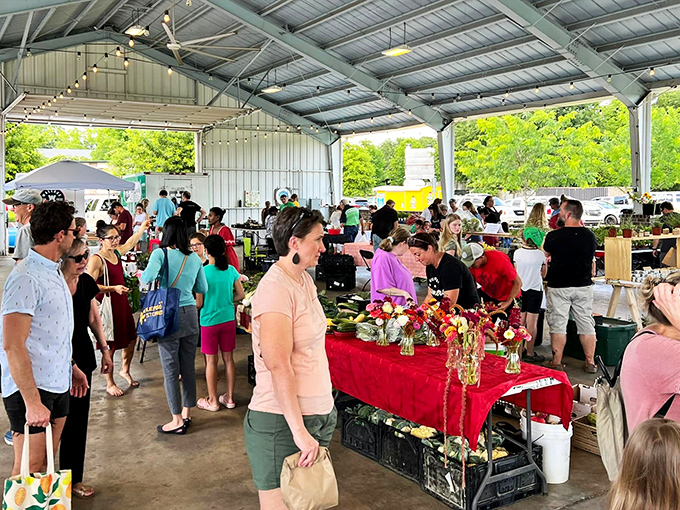 The farmers market buzzes with conversation and commerce, as locals exchange recipes alongside heirloom tomatoes and handpicked flowers.