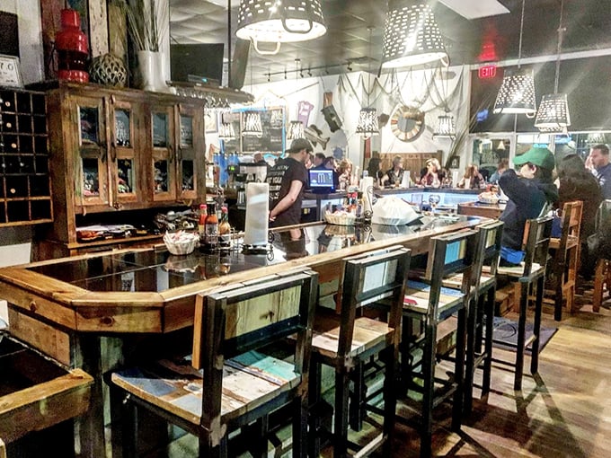 The weathered wood bar feels like it could tell stories of a thousand oysters past. Each stool is a front-row ticket to seafood theater.