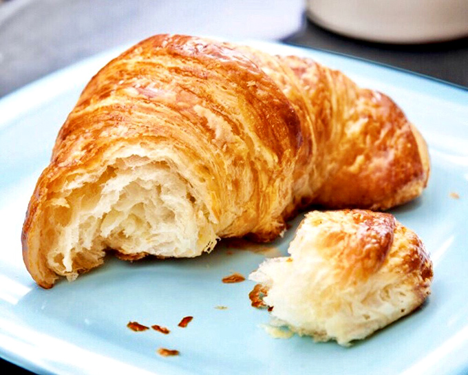 The cross-section reveals the holy grail of croissant architecture &ndash; honeycombed interior chambers created by butter, patience, and wizardry.