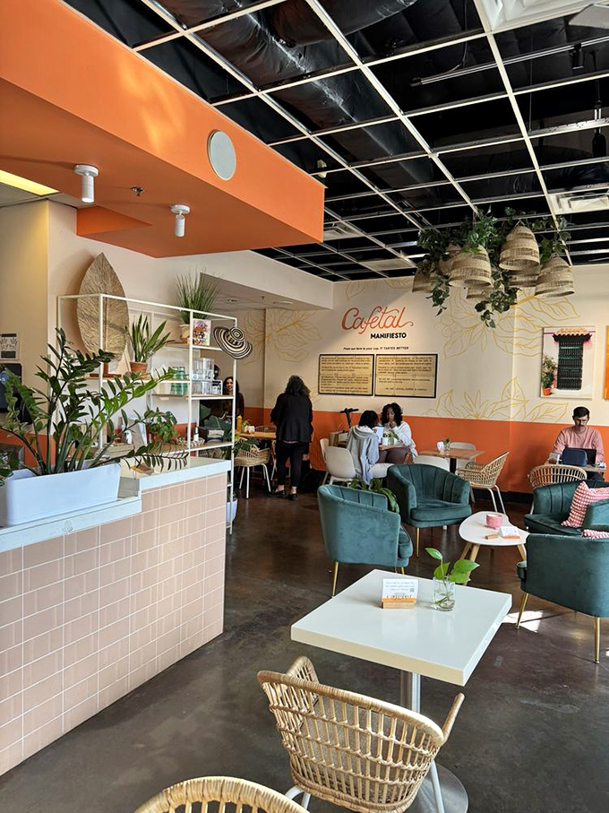 The modern coffee shop&mdash;part workspace, part social hub, all comfort. Those orange walls and woven chairs aren't just d&eacute;cor; they're an invitation to stay awhile.