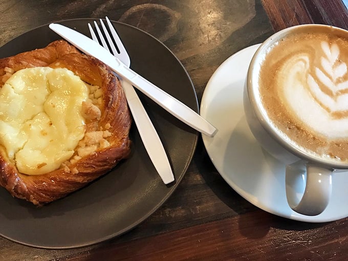Pastry perfection: golden croissant filled with custard alongside artful coffee. A Franco-American alliance that would make diplomats proud.