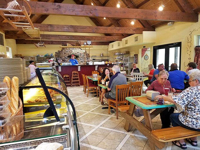 Where locals gather for their daily bread. Under rustic wooden beams, the bakery buzzes with the happy hum of satisfied customers.