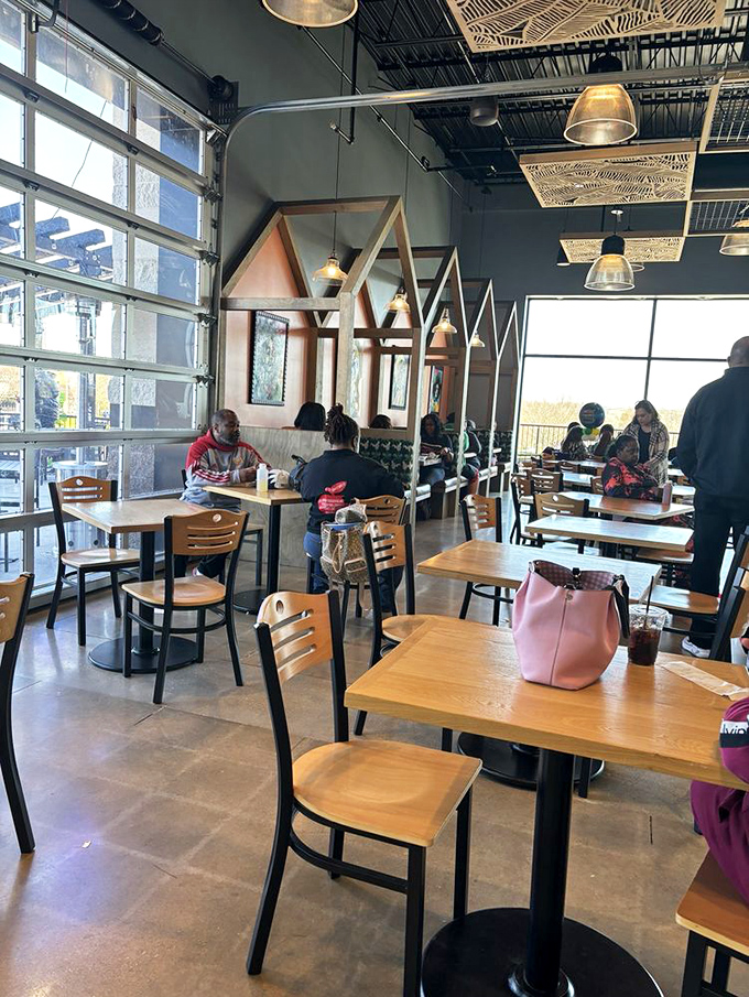 The dining area feels like the living room of that friend who actually knows how to decorate. Those house-shaped booth dividers add whimsical charm.
