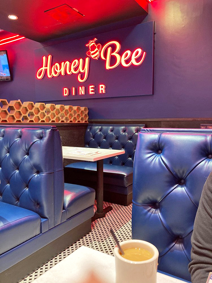 These tufted blue booths have cradled countless conversations, first dates, and food comas. The honeycomb backdrop adds just the right touch of whimsy.