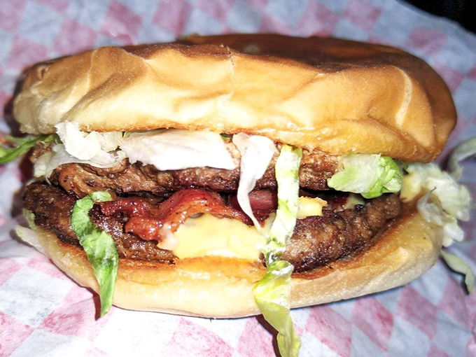 Some burgers whisper. This double cheeseburger announces itself with authority, demanding both hands and your complete attention.