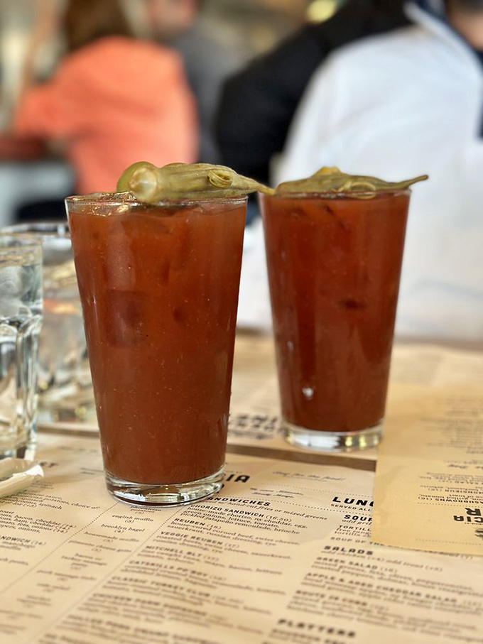 Bloody Marys garnished with attitude and pickles. These drinks aren't just serving alcohol; they're serving a complete appetizer experience in a glass.