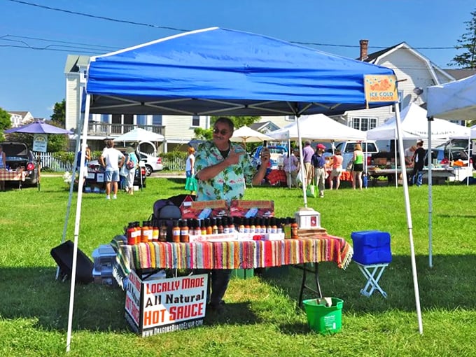 The farmers market vendor's colorful hot sauce collection promises local heat that makes supermarket brands seem like mere condiment pretenders.