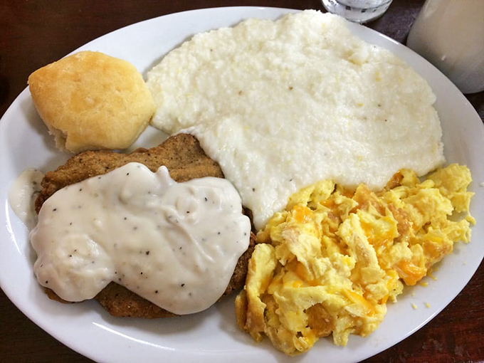 Fried Steak: Country fried steak smothered in pepper gravy alongside fluffy scrambled eggs and grits &ndash; a Southern trinity of flavor.
