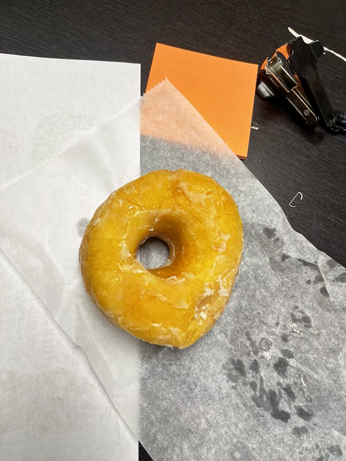 The platonic ideal of a glazed donut, resting on wax paper like the work of art it truly is.
