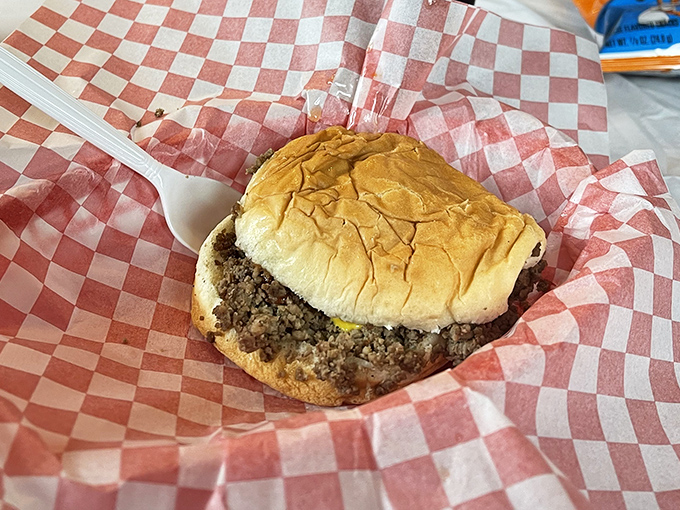 Nestled in its checkered paper cradle, this loose meat masterpiece proves that sometimes the simplest foods create the most devoted followings.