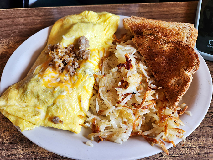 An omelet that refuses to be a dainty French interpretation&mdash;this is American breakfast abundance with hash browns crisped to golden perfection and toast standing by for support.