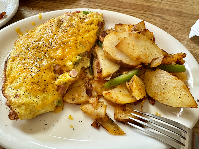 This omelet didn't just happen&mdash;it was crafted with intent, like a savory work of art that happens to pair perfectly with those golden-edged potatoes.