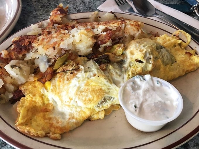 This isn't just an omelet—it's a golden envelope delivering a message of hope and happiness, with a side of perfectly crisped potatoes.